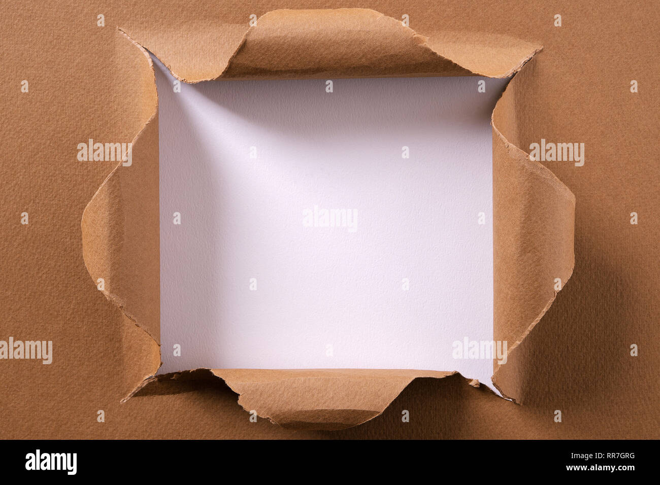 Torn brown paper square hole background frame Stock Photo - Alamy