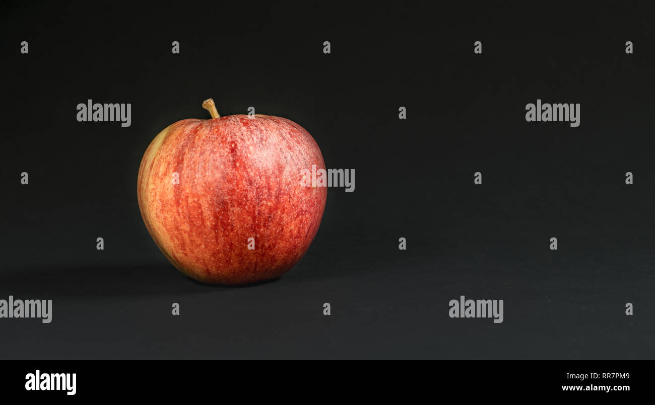 Red apple in the shade on a black background. Isolated Stock Photo - Alamy