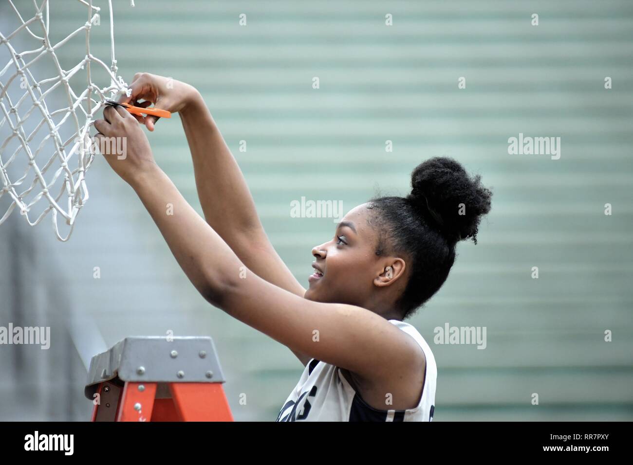 Player participating in a traditional cutting down of the net following ...