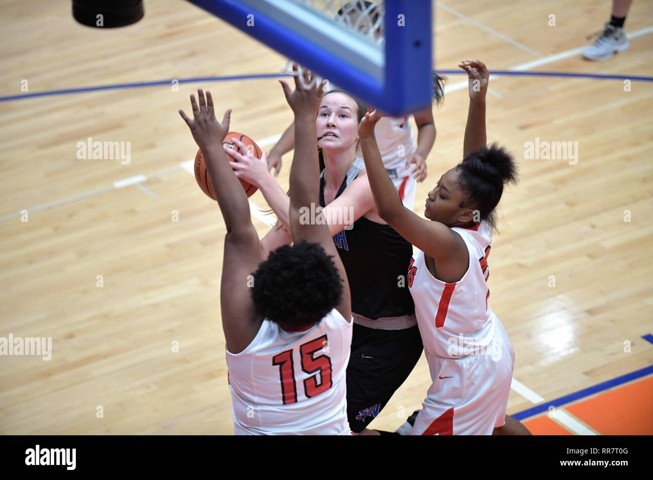 After pulling down an offensive rebound, a player is surrounded by ...