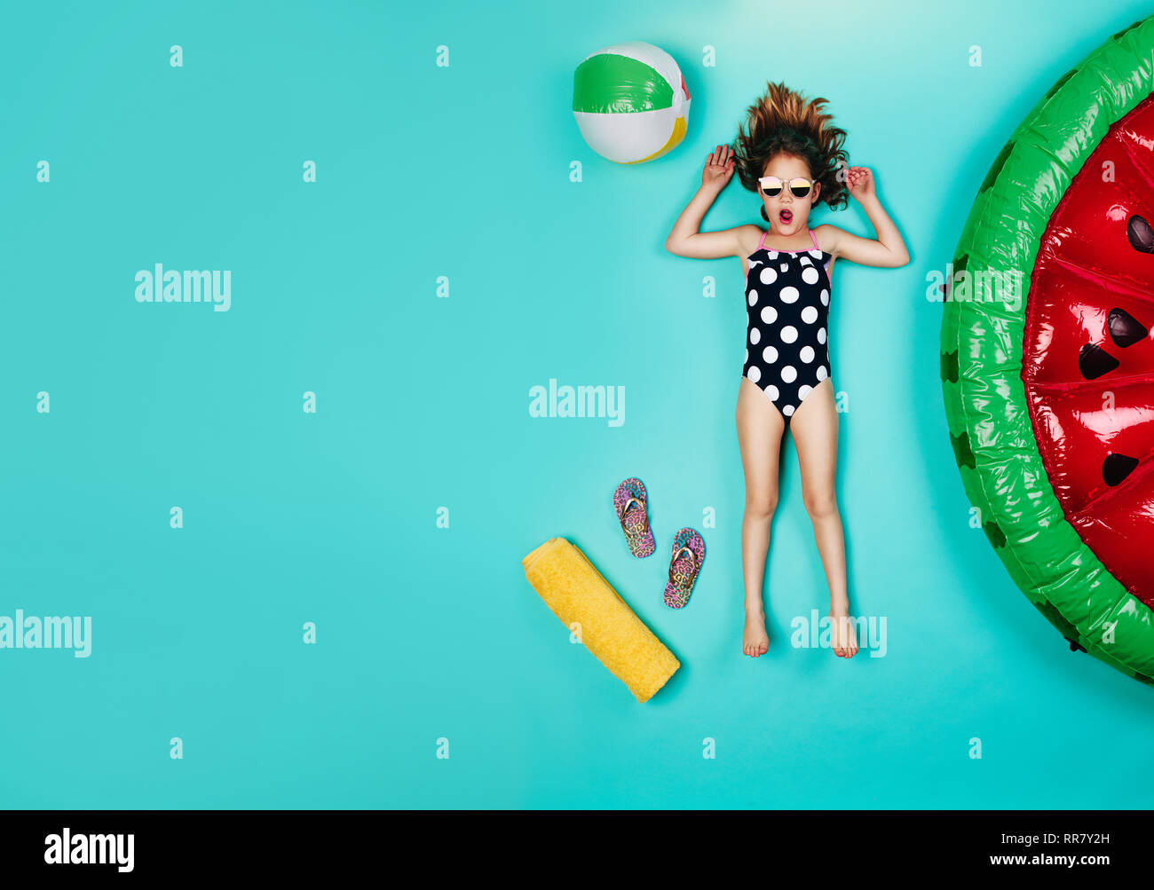 Top View Of Excited Girl In Swimwear Lying On Blue Background Girl