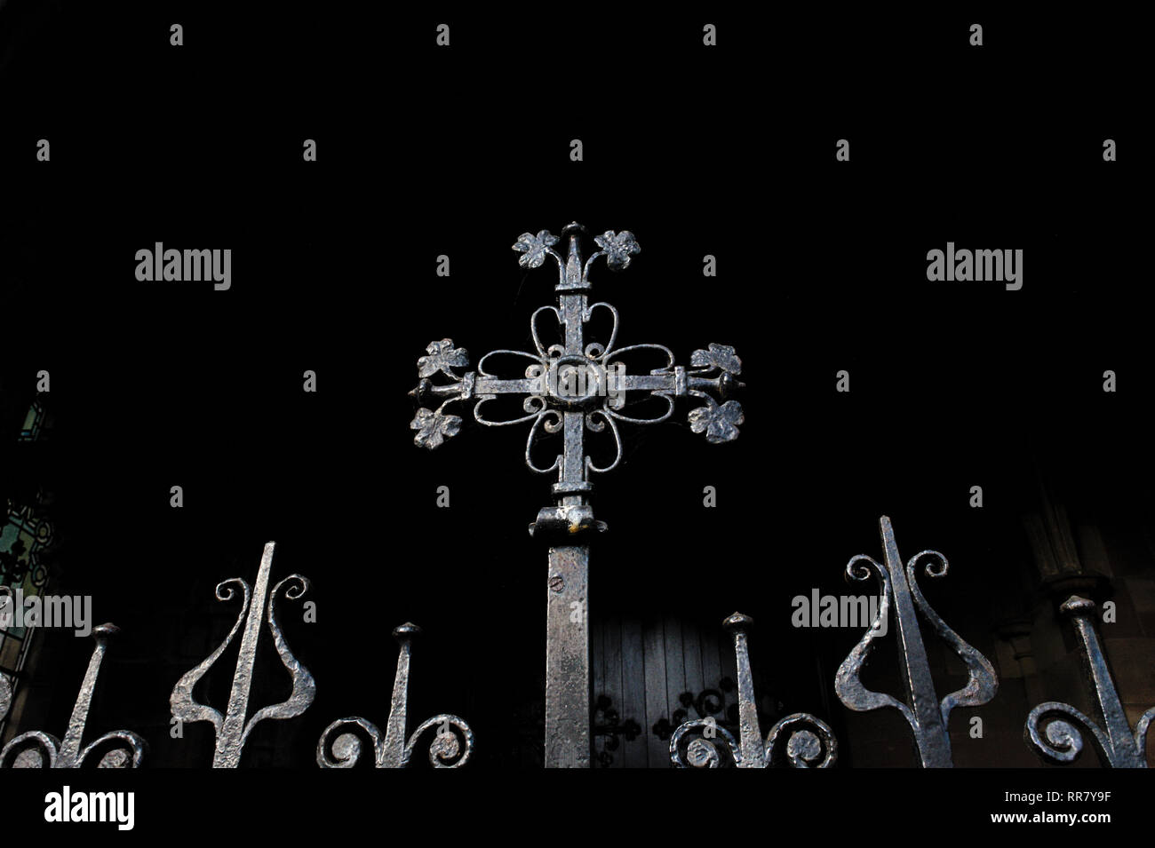 Black and white photo of metal gate with cross, entrance to the church ...