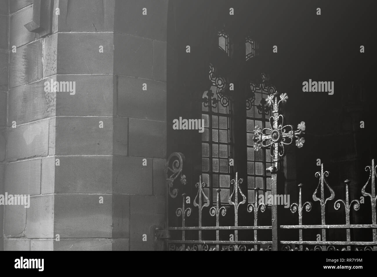 Black and white photo of metal gate with cross, entrance to the church ...