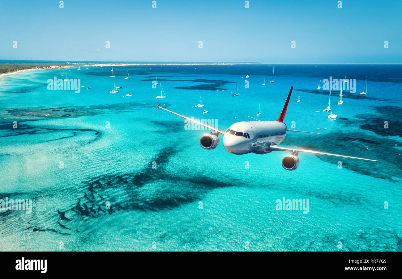 Airplane is flying over islands and sea at sunrise in summer. Landscape ...