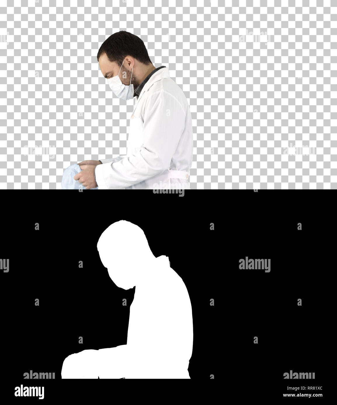 On Alpha Matte. Medium shot side view. Walking doctor putting on mask ...