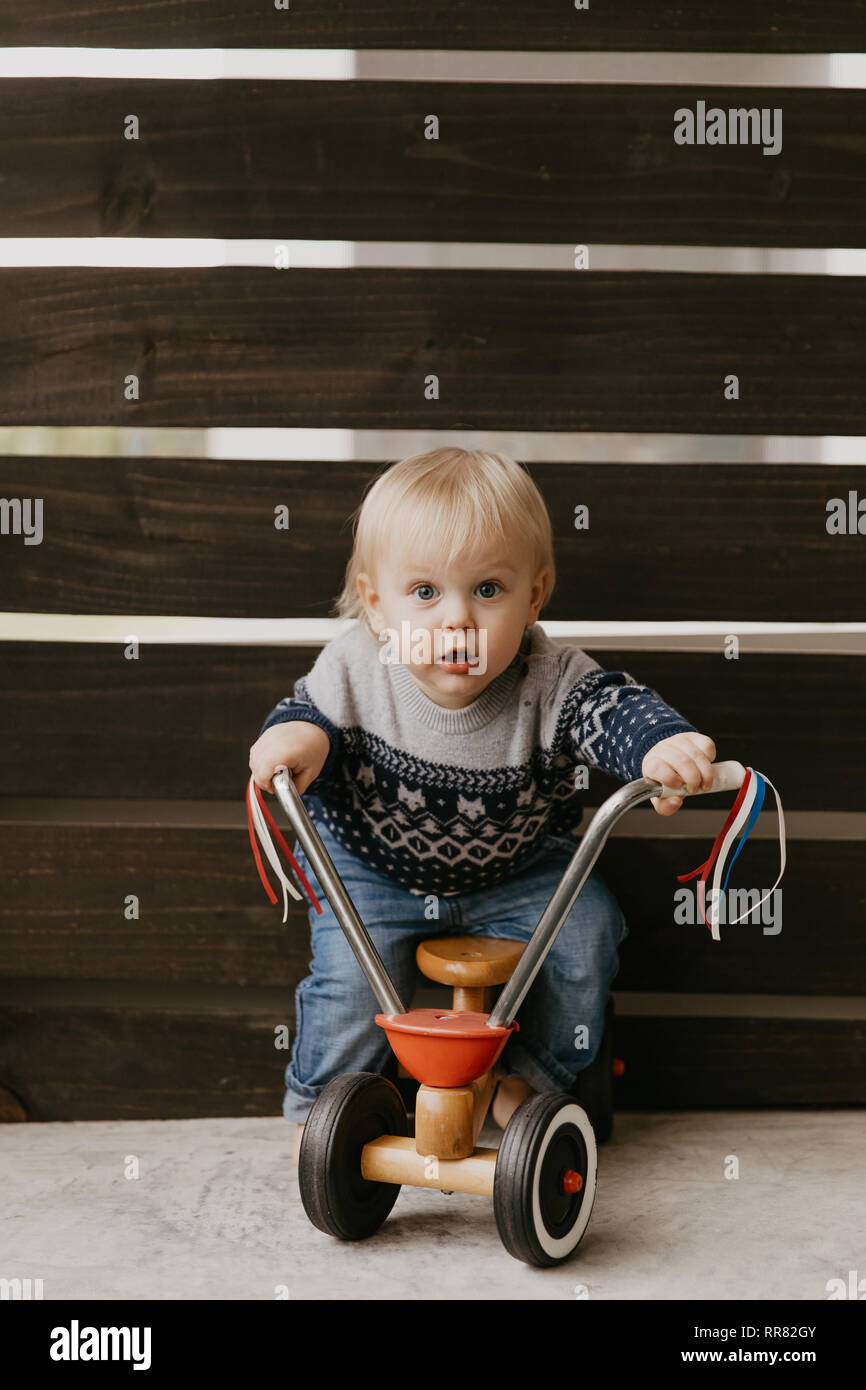 Happy child riding tricycle hi-res stock photography and images - Alamy