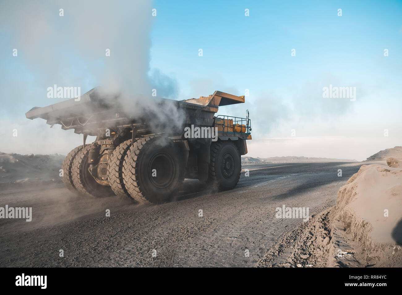 Large quarry dump truck. Loading the rock in dumper. Loading coal into ...