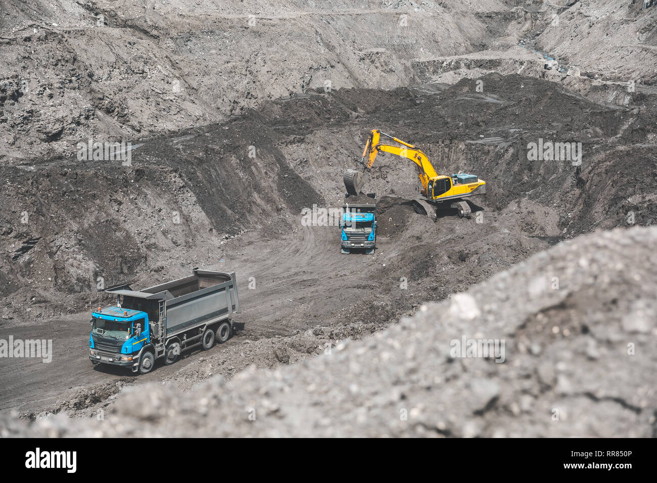 Large quarry dump truck. Loading the rock in dumper. Loading coal into body truck. Production ...