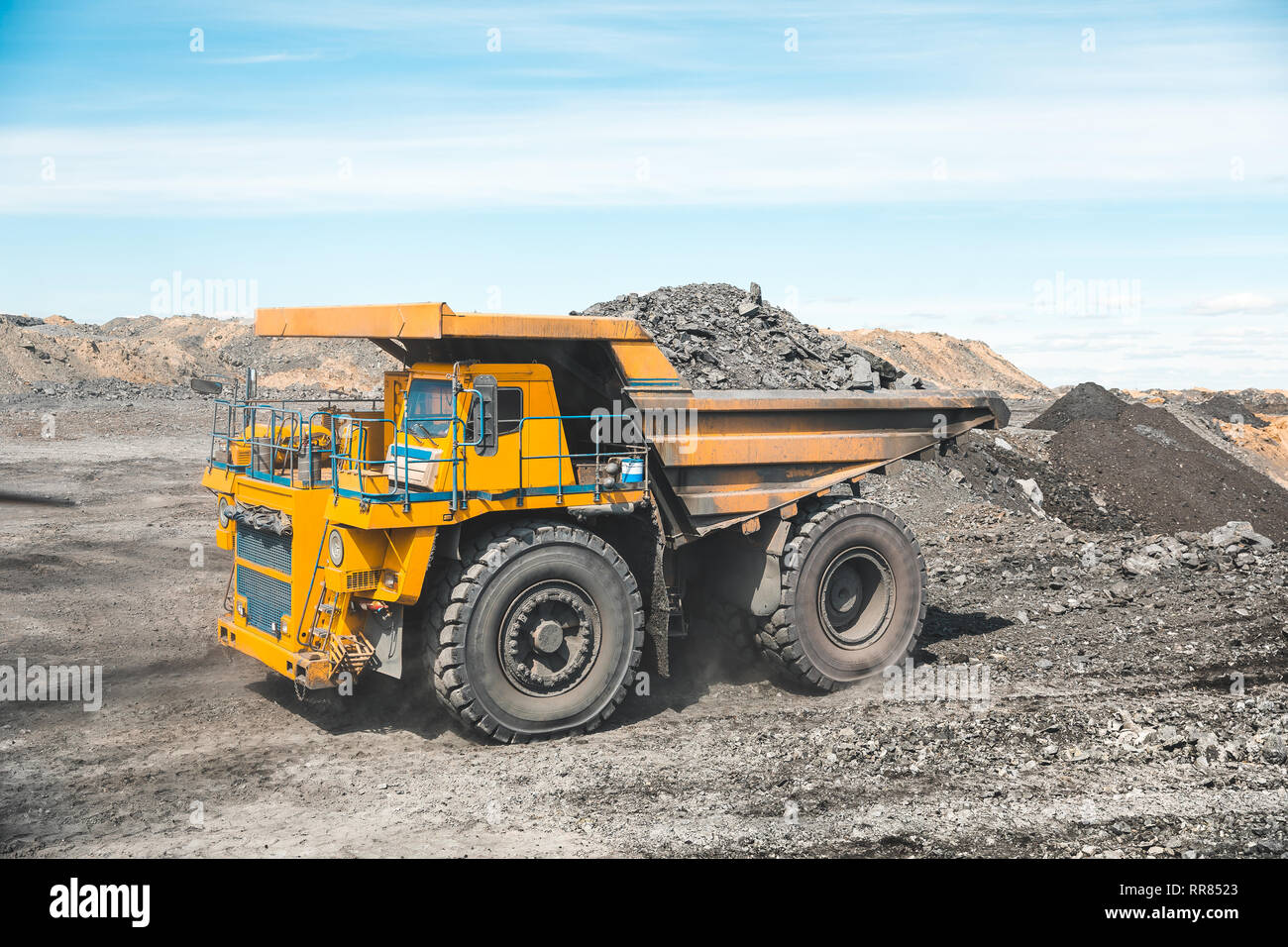 Large quarry dump truck. Loading the rock in dumper. Loading coal into body truck. Production ...