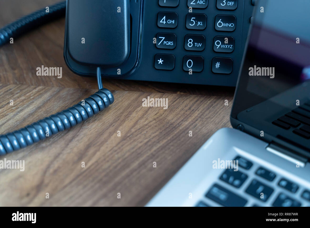 Office Telephone console on wood table Stock Photo - Alamy