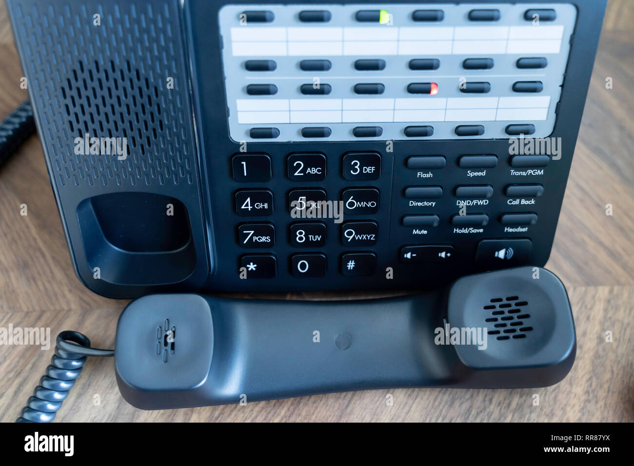 Office Telephone console on wood table Stock Photo - Alamy