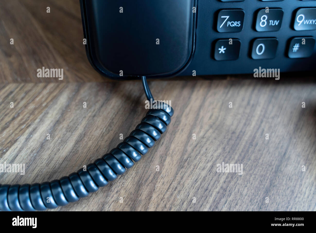 Office Telephone console on wood table Stock Photo - Alamy