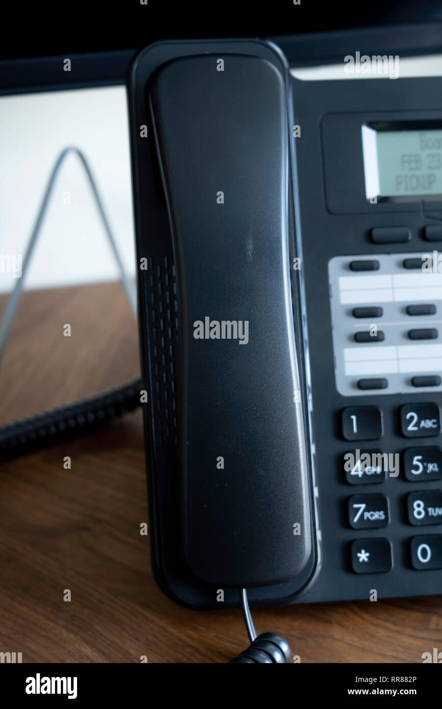 Office Telephone console on wood table Stock Photo - Alamy