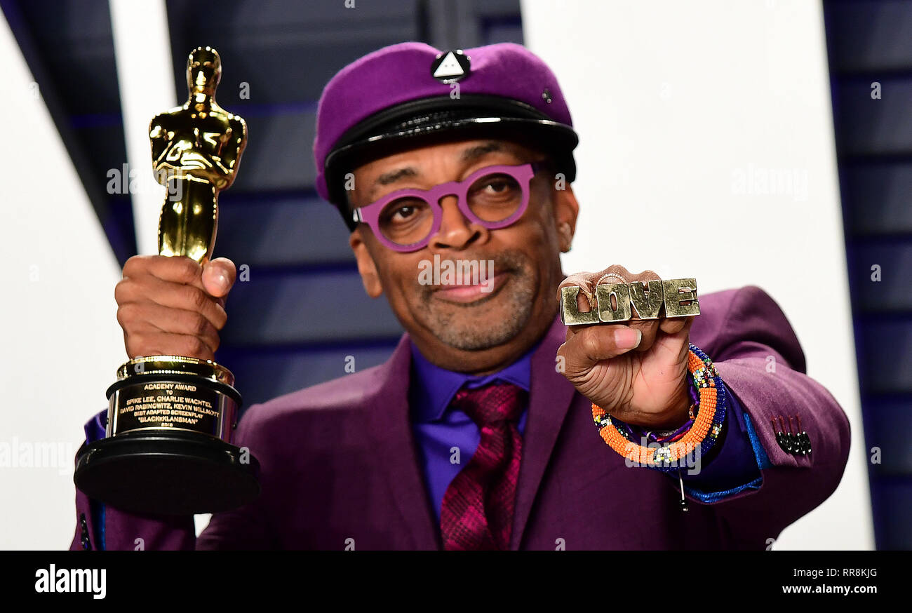 Spike Lee holds up his Oscar for Best Adapted Screenplay and a ring ...