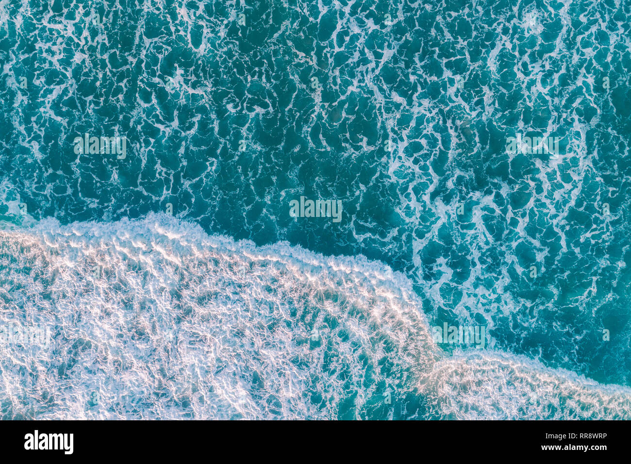 Aerial view - looking down at beautiful ocean waves and white foam ...