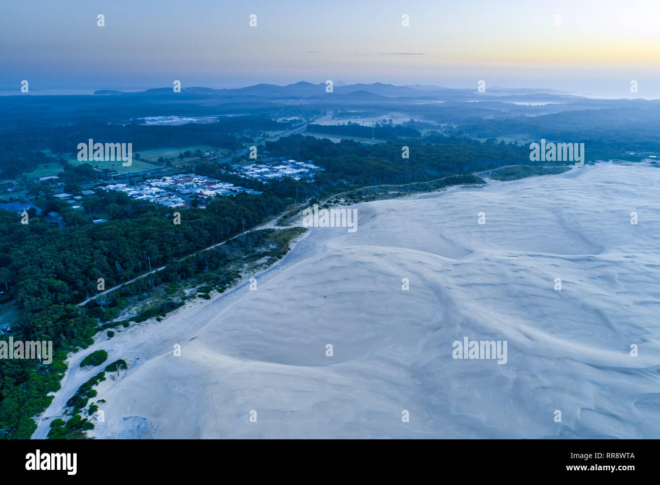 Beautiful sand dunes and and hills near the ocean at dawn. Anna Bay ...