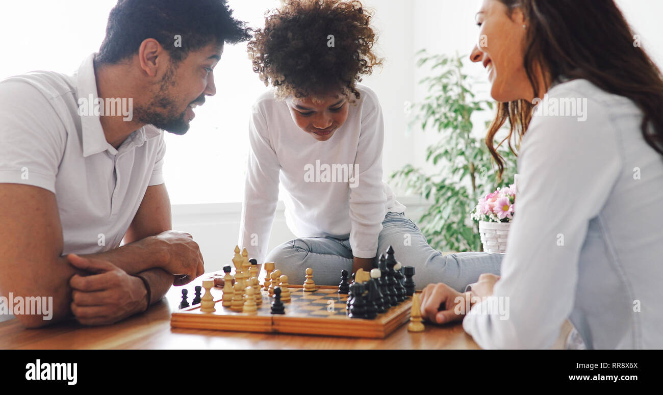 Happy family playing chess together at home Stock Photo - Alamy