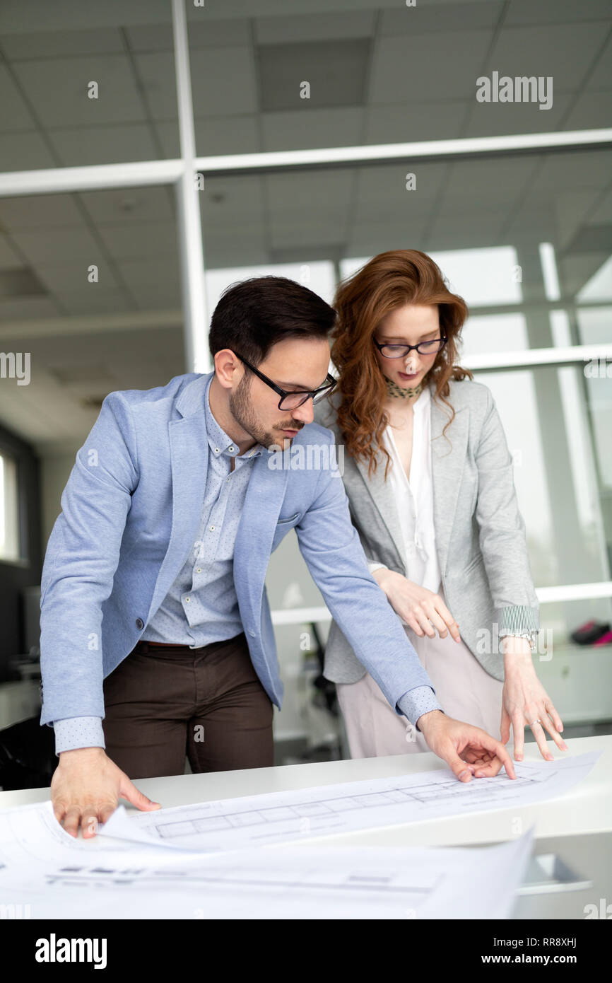 Group of architects working on new project Stock Photo - Alamy