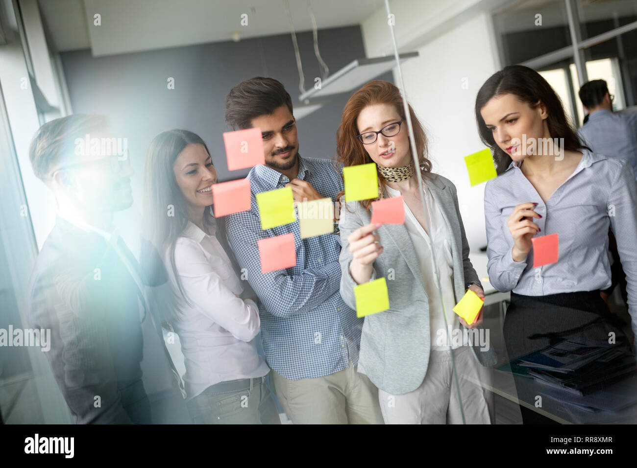 Female colleagues smiling reviewing project hi-res stock photography ...