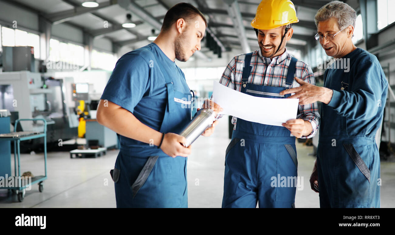 Team Of Engineers Having Discussion In Factory Stock Photo - Alamy