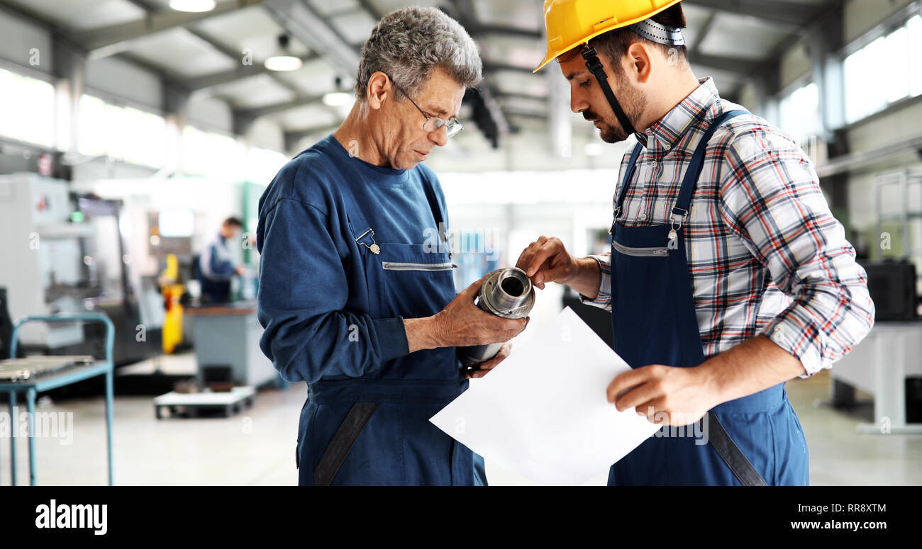 Team Of Engineers Having Discussion In Factory Stock Photo - Alamy