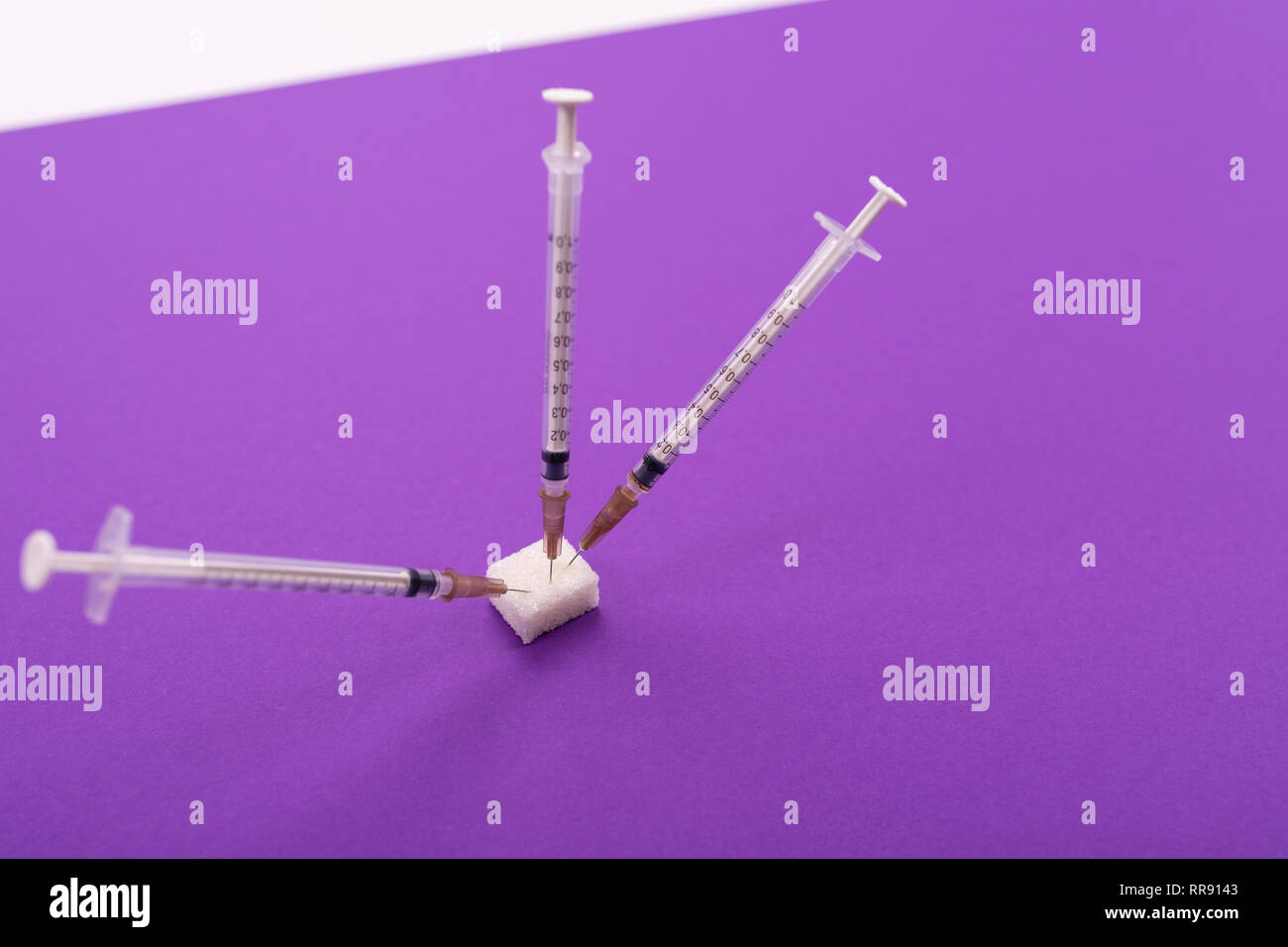 white medical syringes stick out of a piece of sugar Stock Photo - Alamy