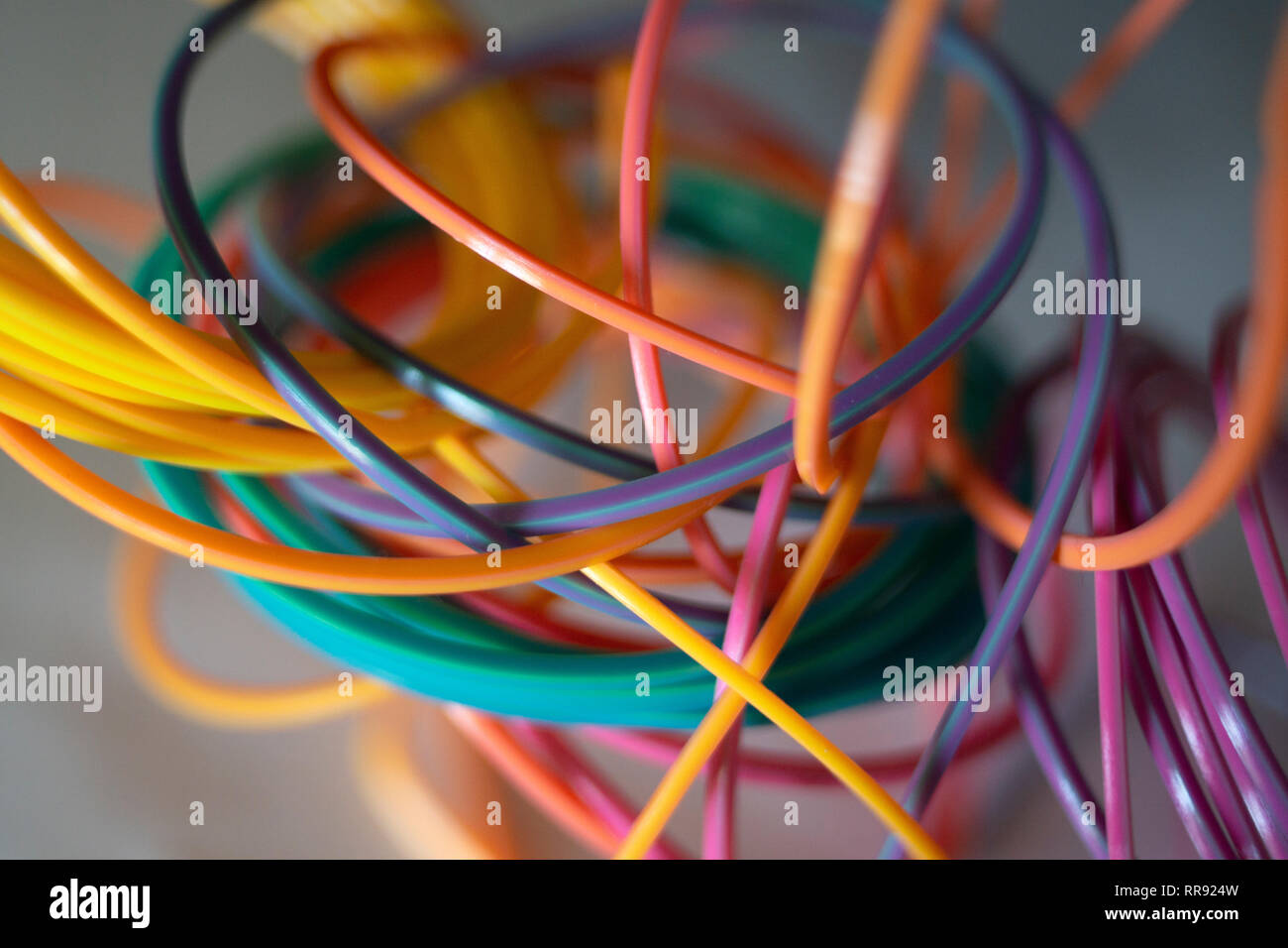 Tangled mass of coloured plastic wires Stock Photo - Alamy