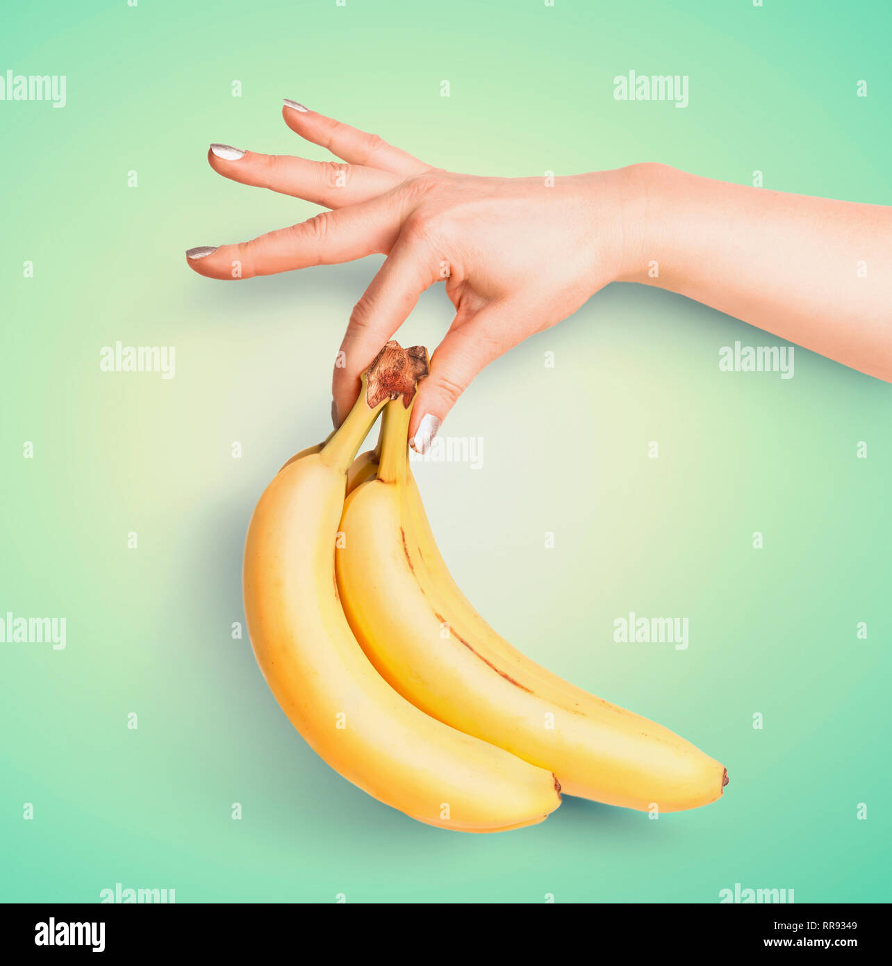 Bunch of organic bananas in female hand at turquoise background. Summer ...