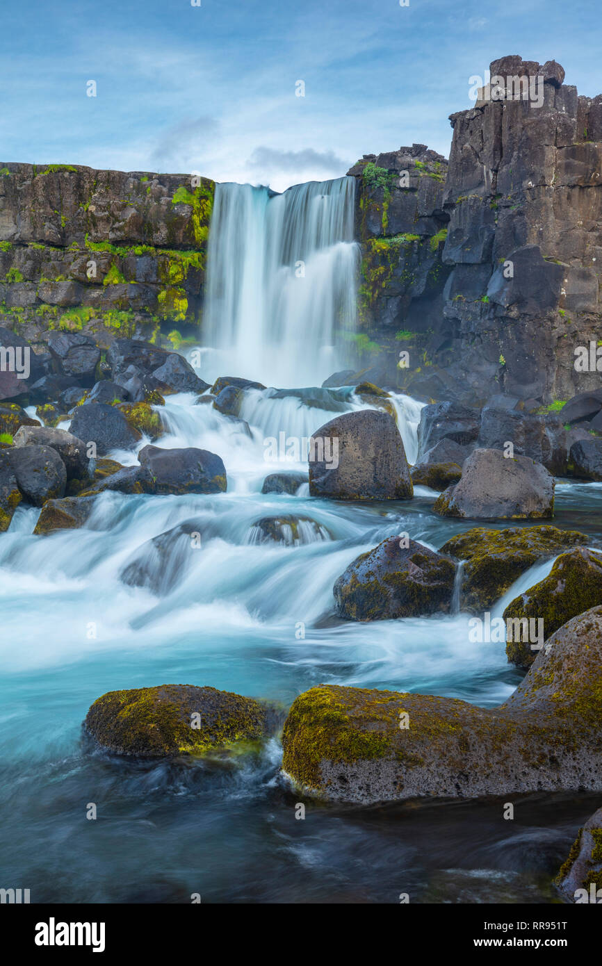Oxararfoss waterfall flowing over the Almannagja cliffs, Pingvellir ...