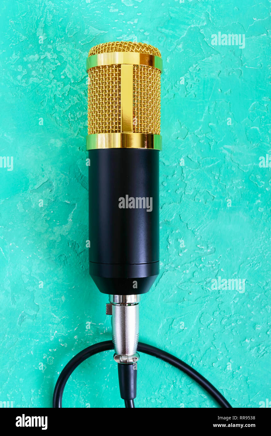Beautiful golden microphone on a bright background. The top view Stock ...