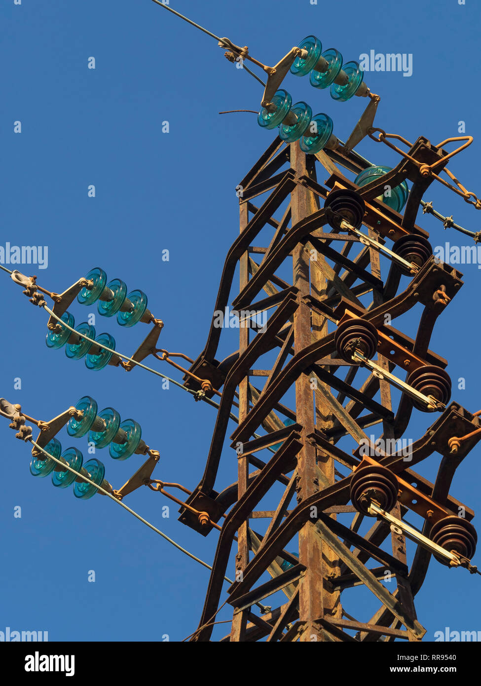 upper part of a old rusty tower (phylon) with glass insulators, part of ...