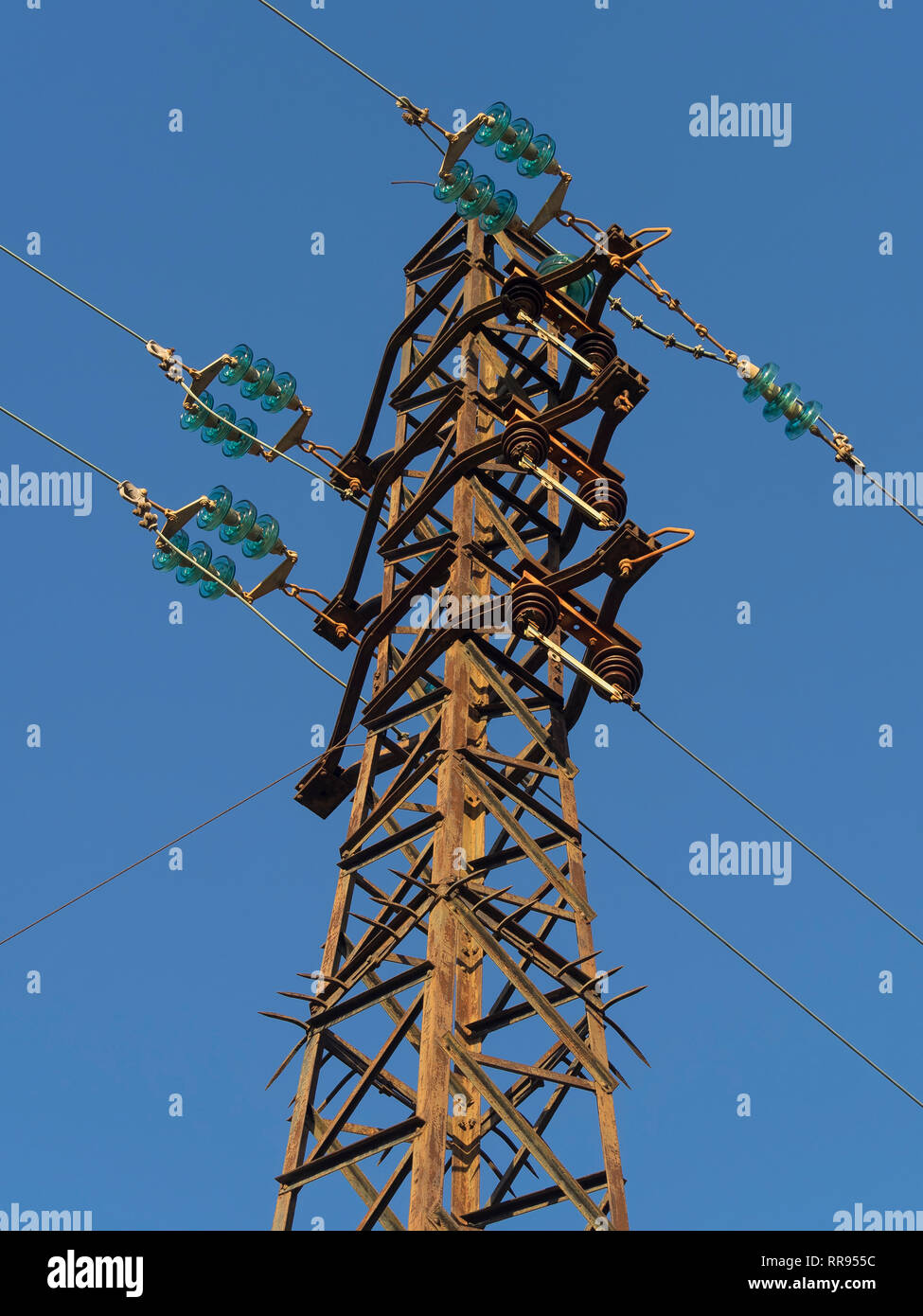 old rusty tower (phylon) with glass insulators, part of a power ...