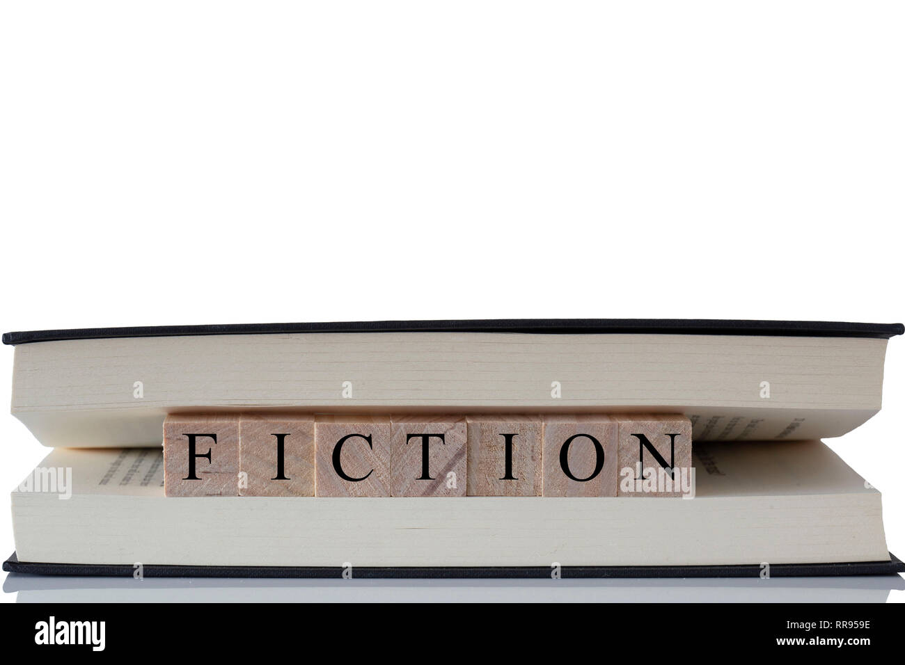 Fiction written on wooden blocks inside a book isolated on a white ...