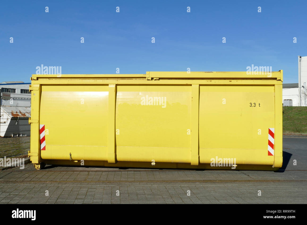 Yellow Container for rubble, blue sky Stock Photo - Alamy