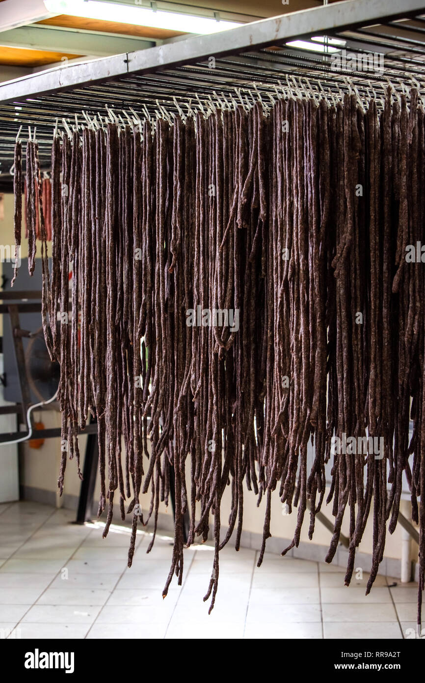 Dry meat sticks drying on a rack Stock Photo - Alamy