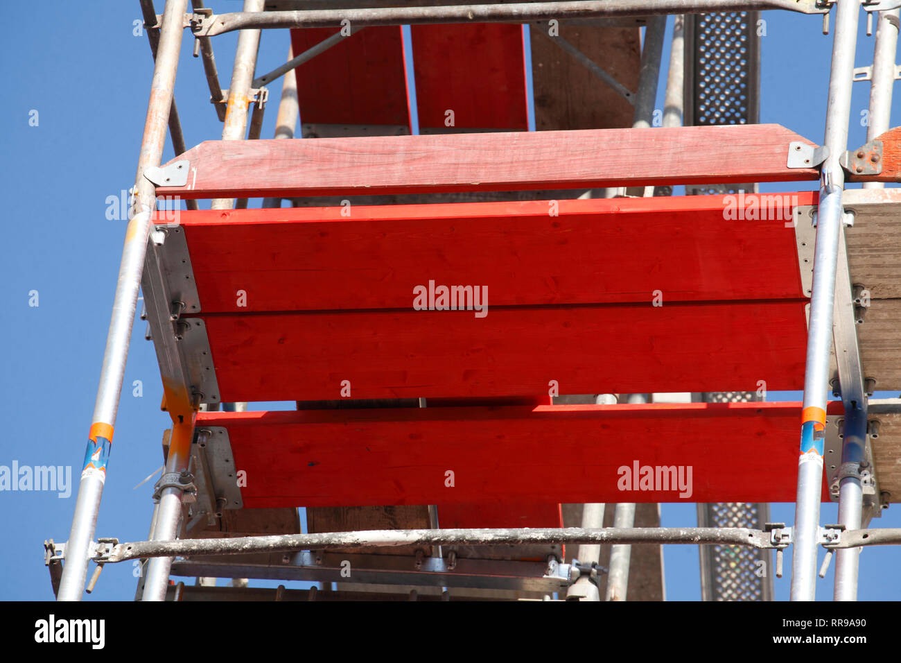 Construction site, scaffolding, red boards Stock Photo - Alamy