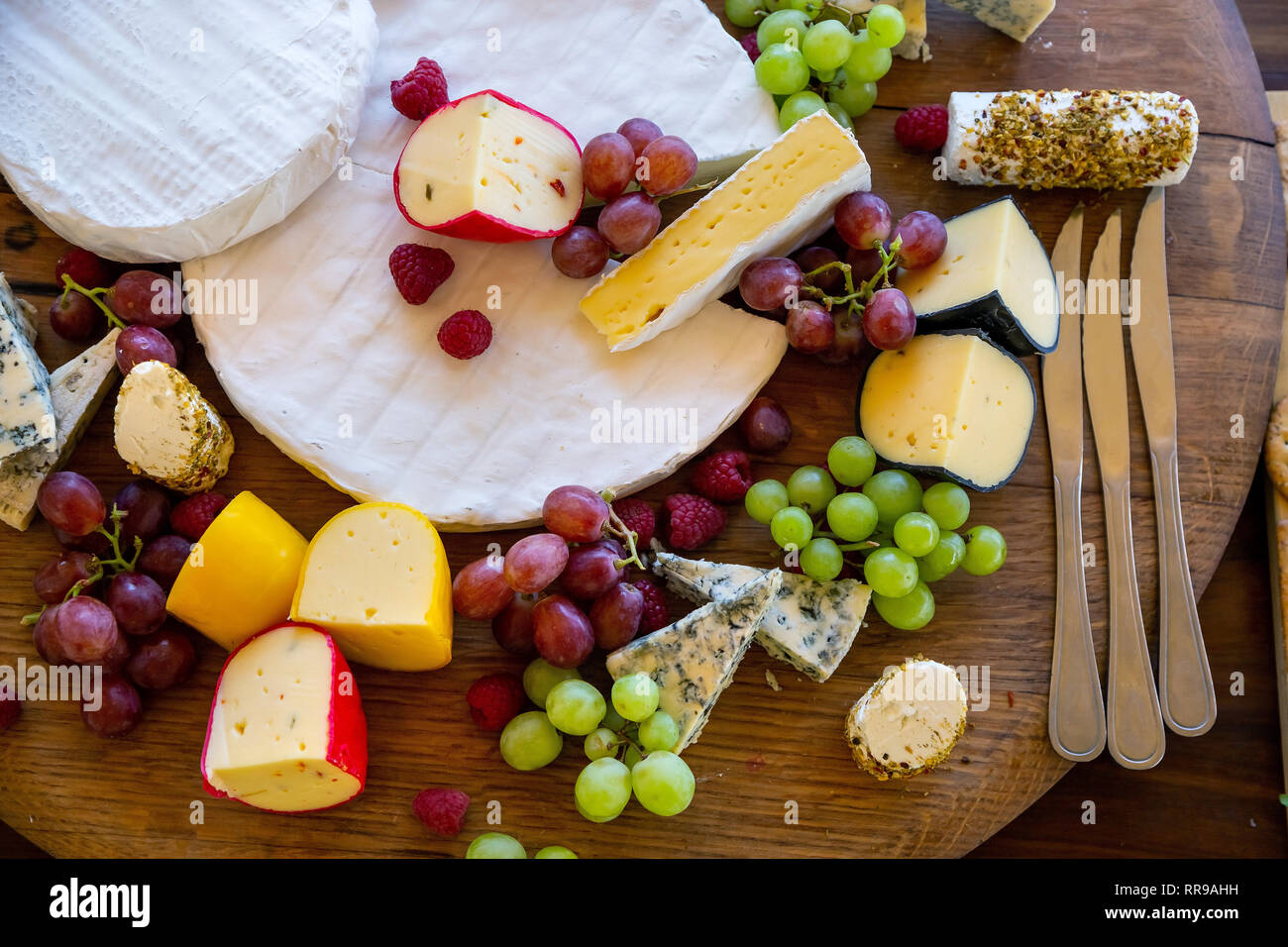 Cheese platter with grapes and crackers Stock Photo - Alamy