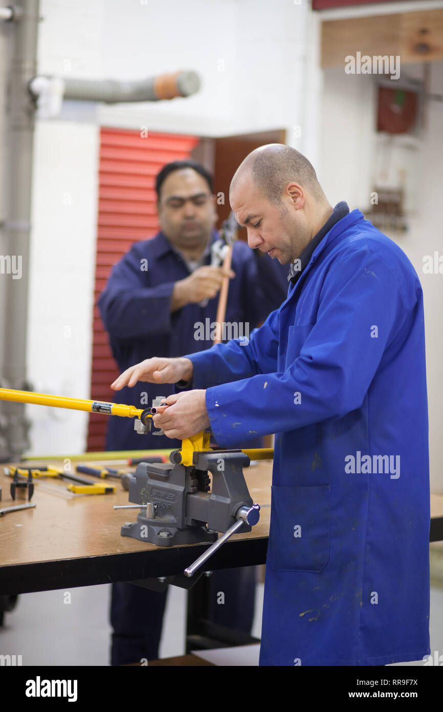 adults in a further education college studying plumbing Stock Photo - Alamy
