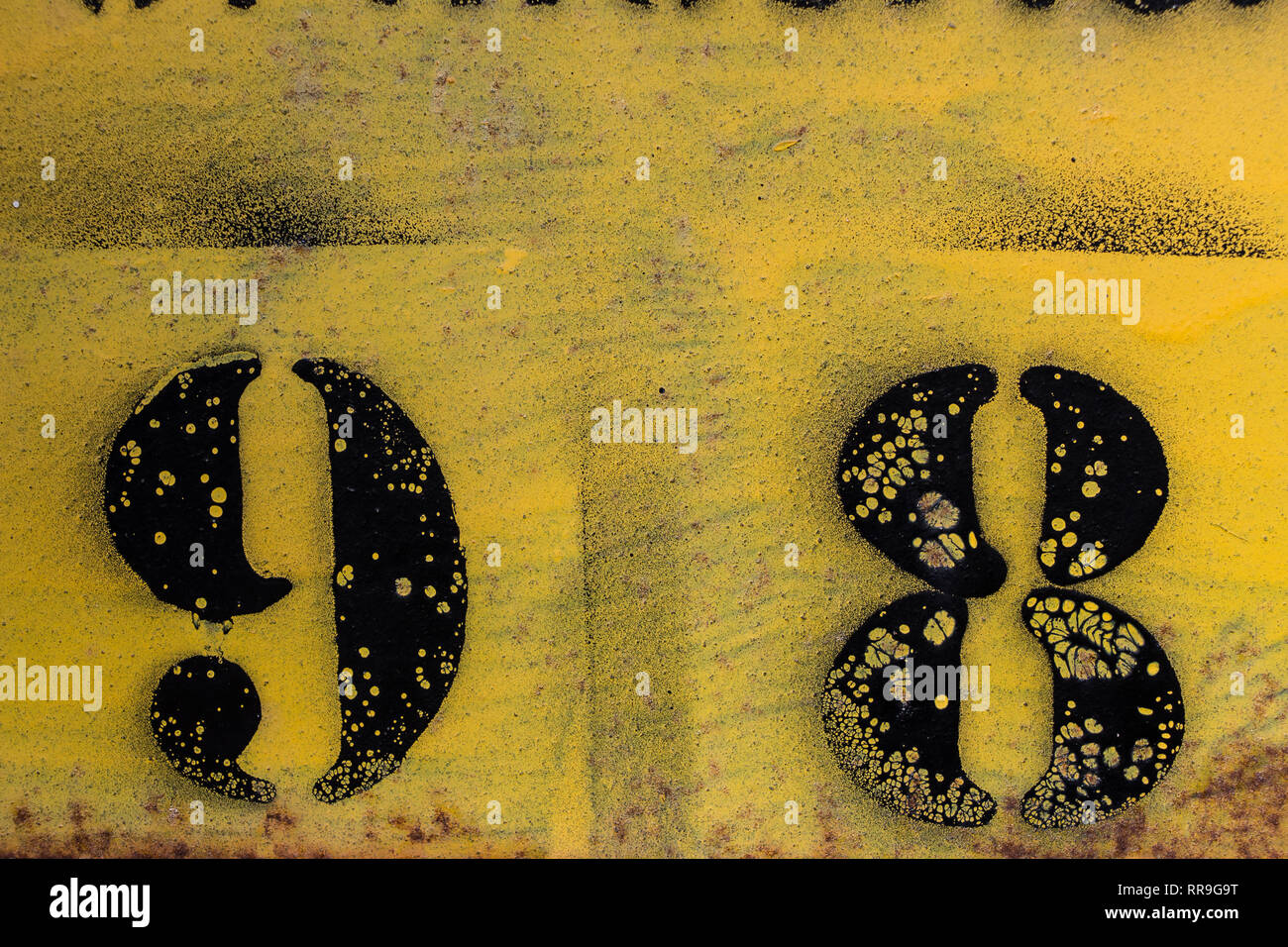 black number stencil painted on yellow background, number 98, number ...