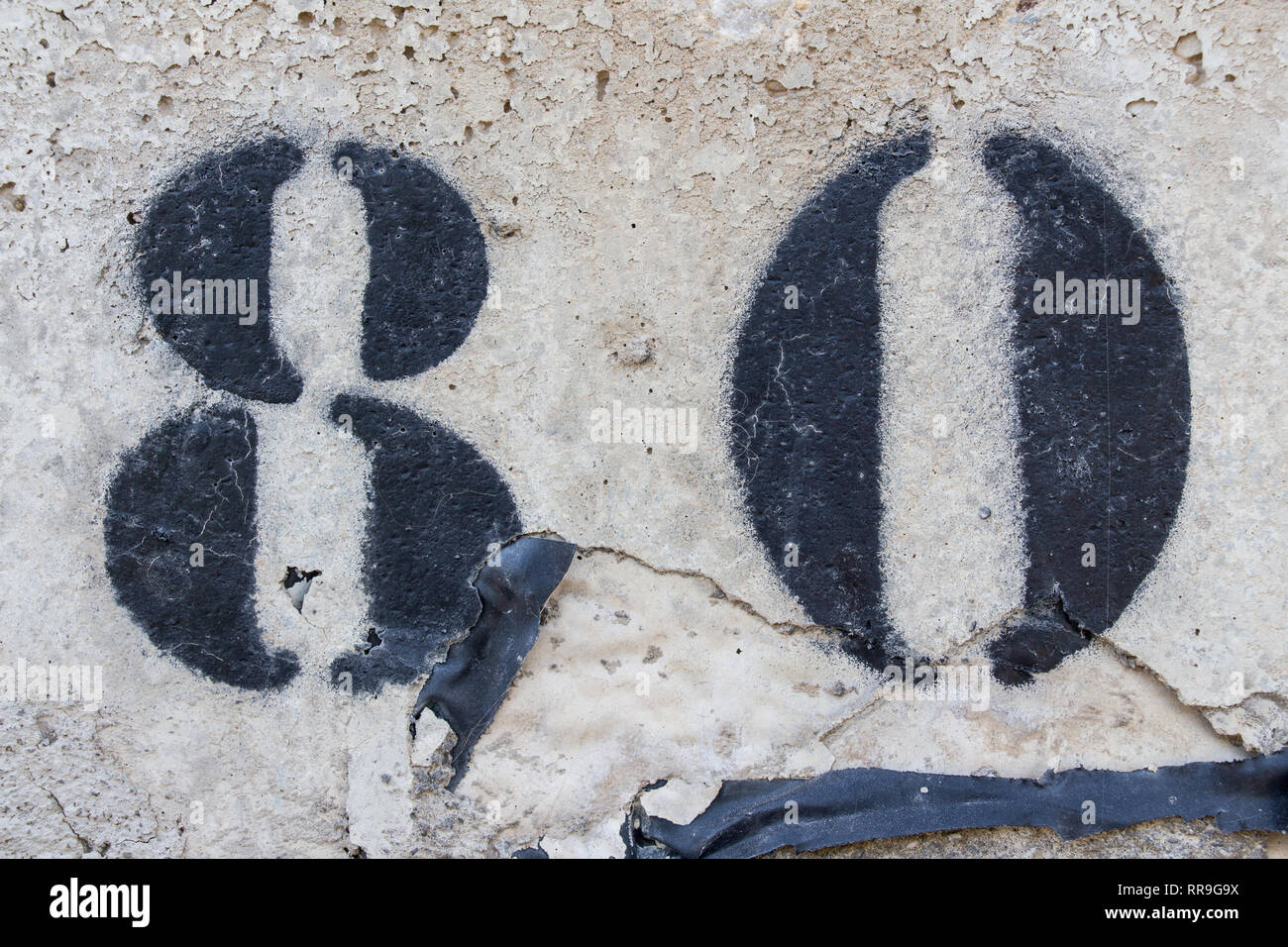 number eighty painted stencil on concrete wall, number 80 Stock Photo ...