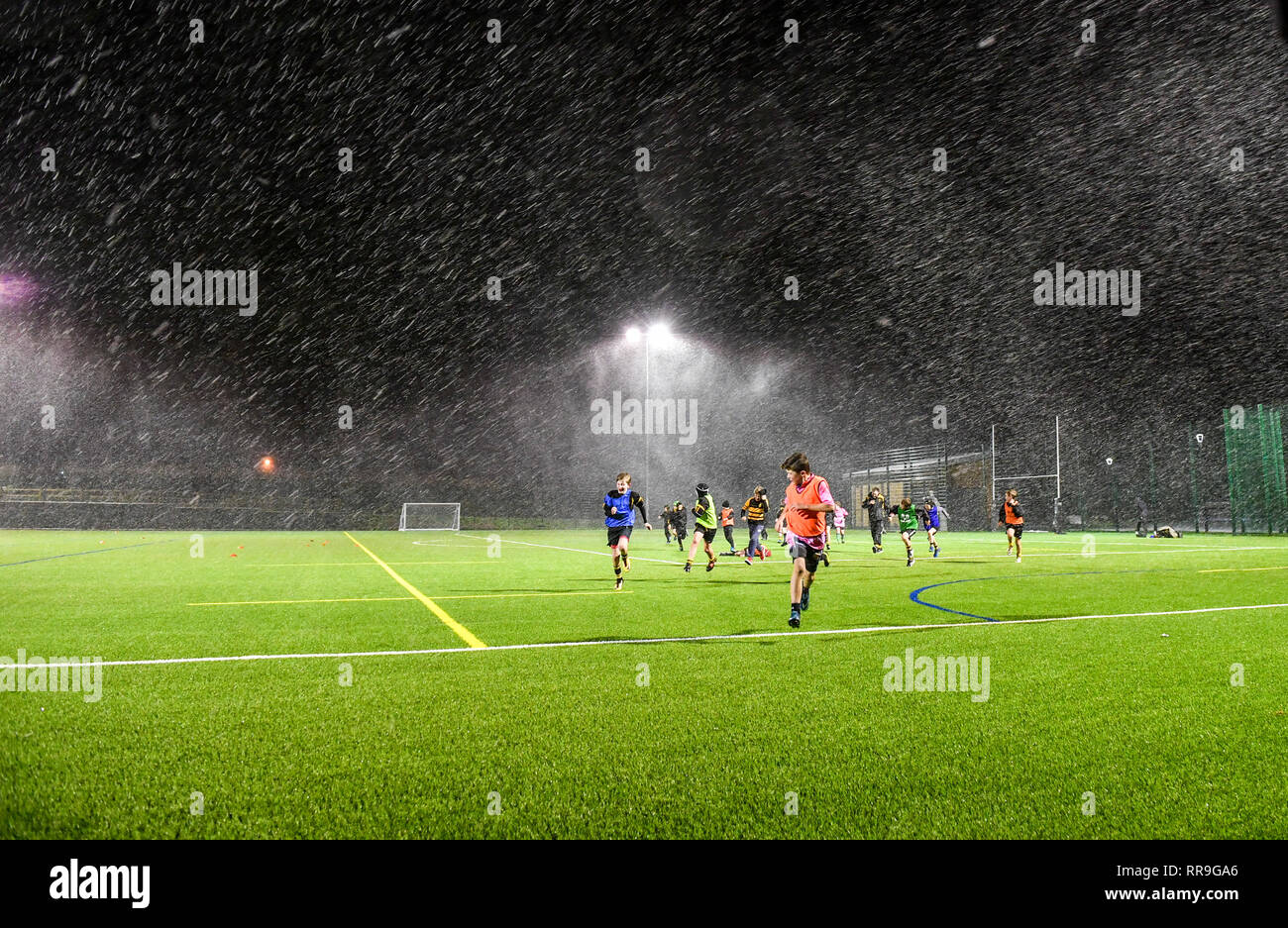All weather pitch in snow storm under flood light Stock Photo - Alamy