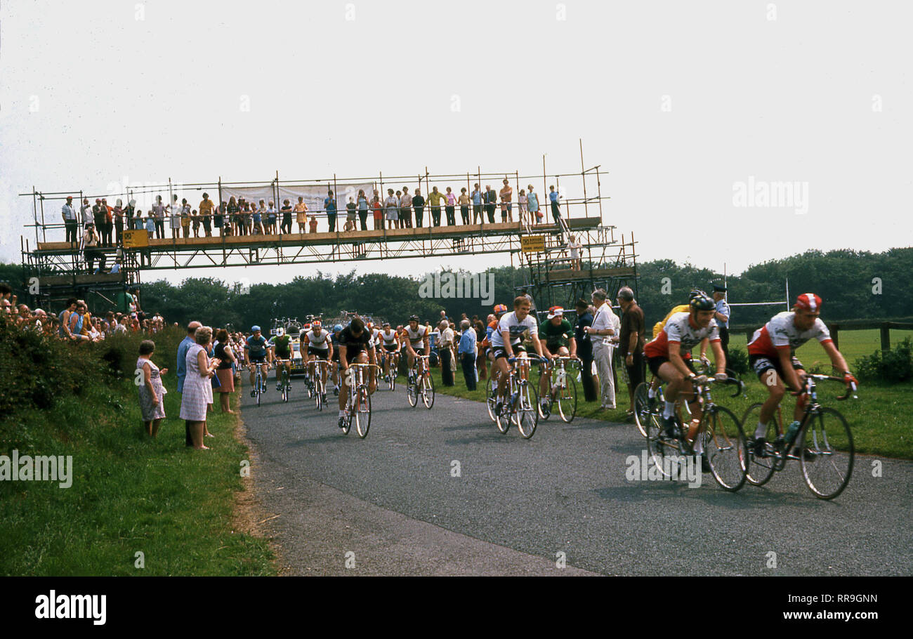 1960s, spectators standing on a gantry watching cyclists competing in ...