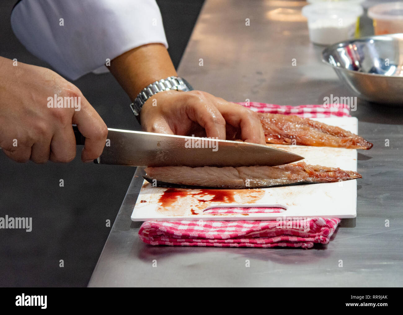 Chef cutting fish, Chef slices fish fresh on Board in the kitchen Stock ...