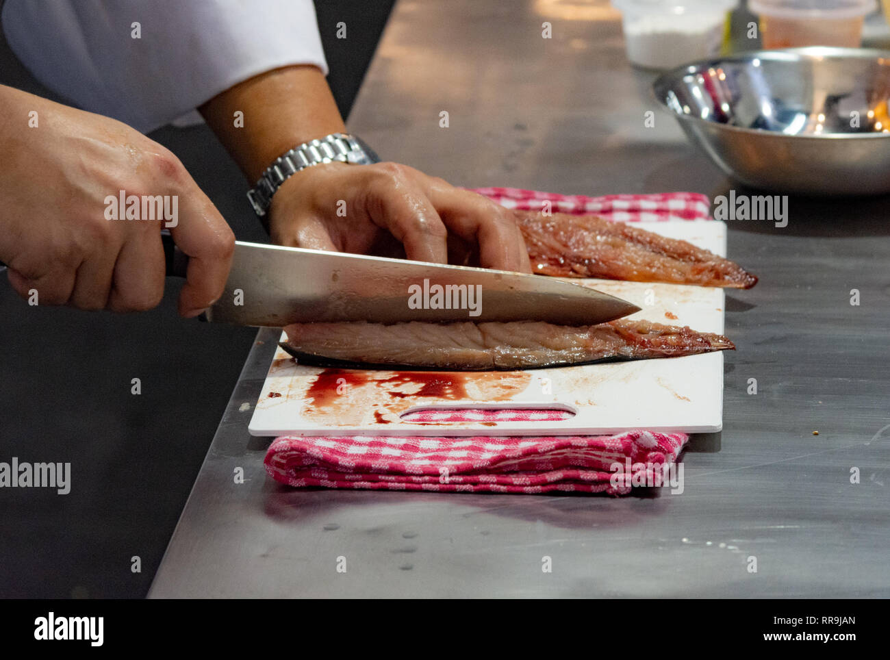 Chef cutting fish, Chef slices fish fresh on Board in the kitchen Stock ...