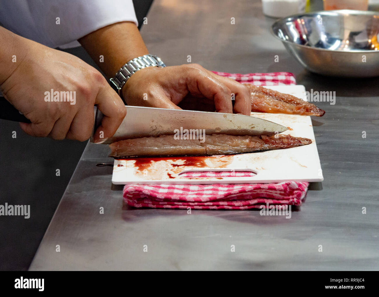 Chef cutting fish, Chef slices fish fresh on Board in the kitchen Stock ...