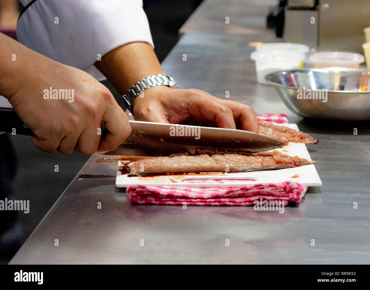 Chef cutting fish, Chef slices fish fresh on Board in the kitchen Stock ...