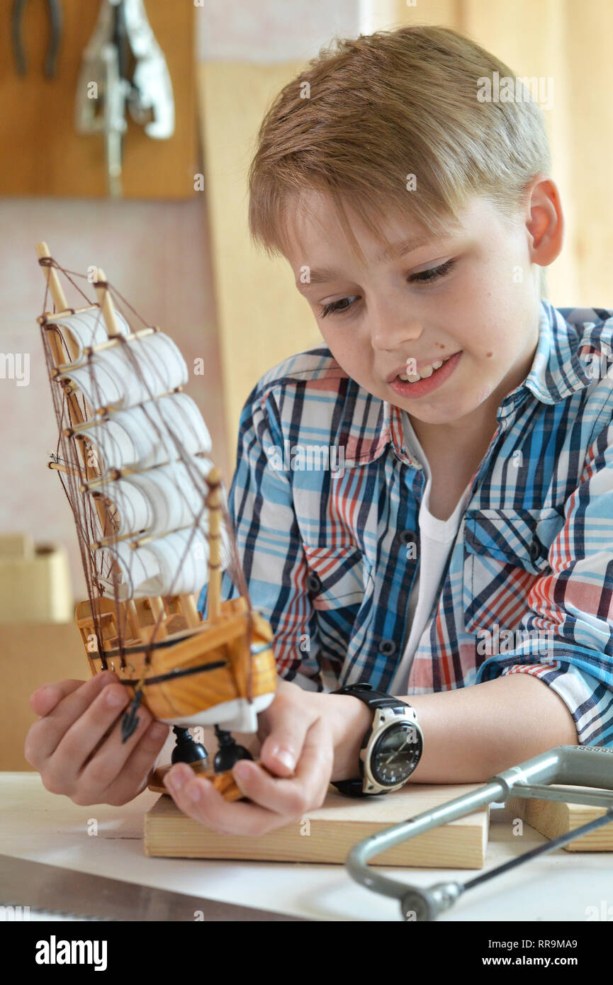 Portrait of cute little boy working with wood in workshop Stock Photo ...