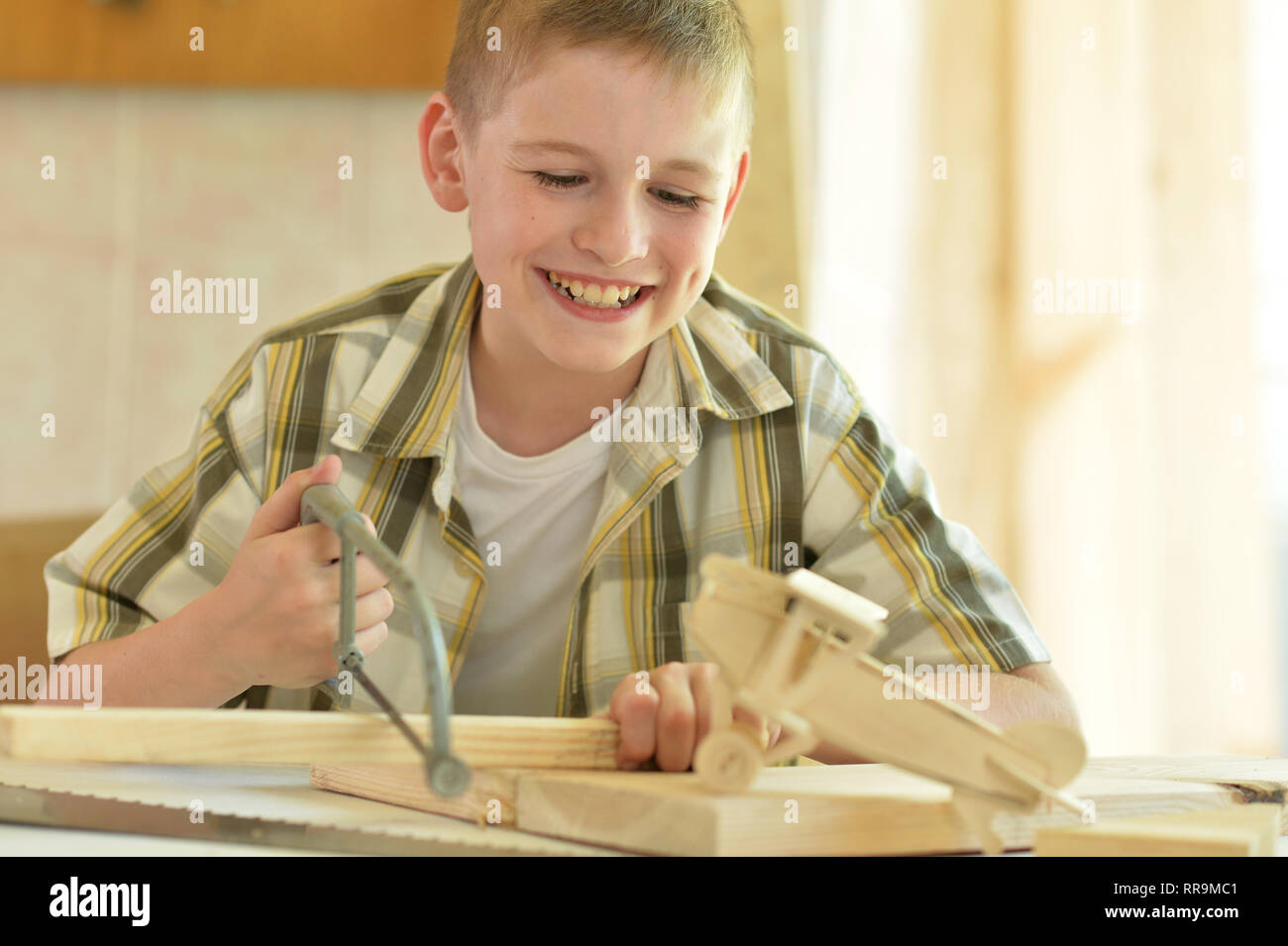 Portrait of cute little boy working with wood in workshop Stock Photo ...
