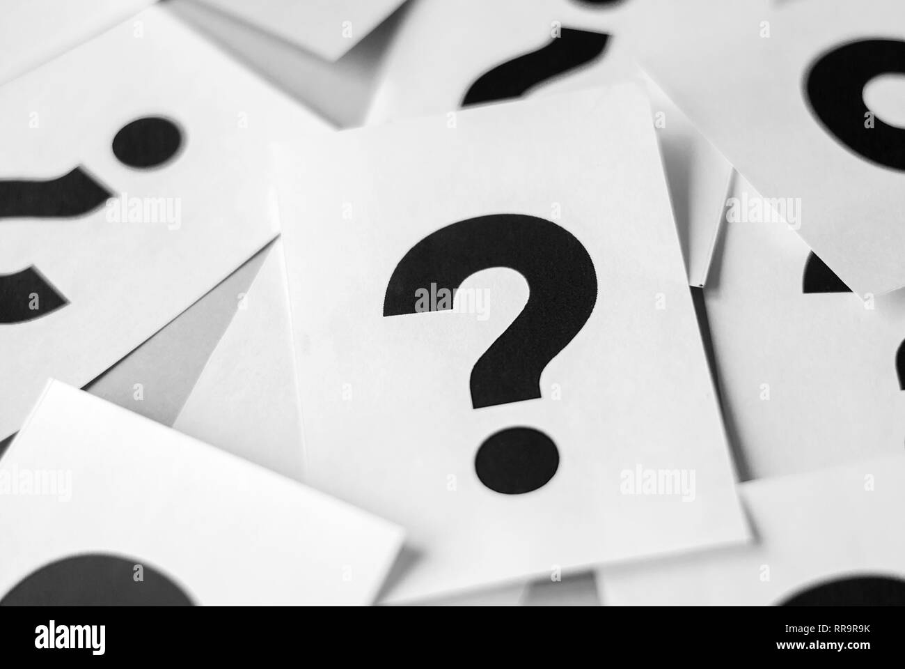 Pile of white cards with black question marks viewed in full frame ...