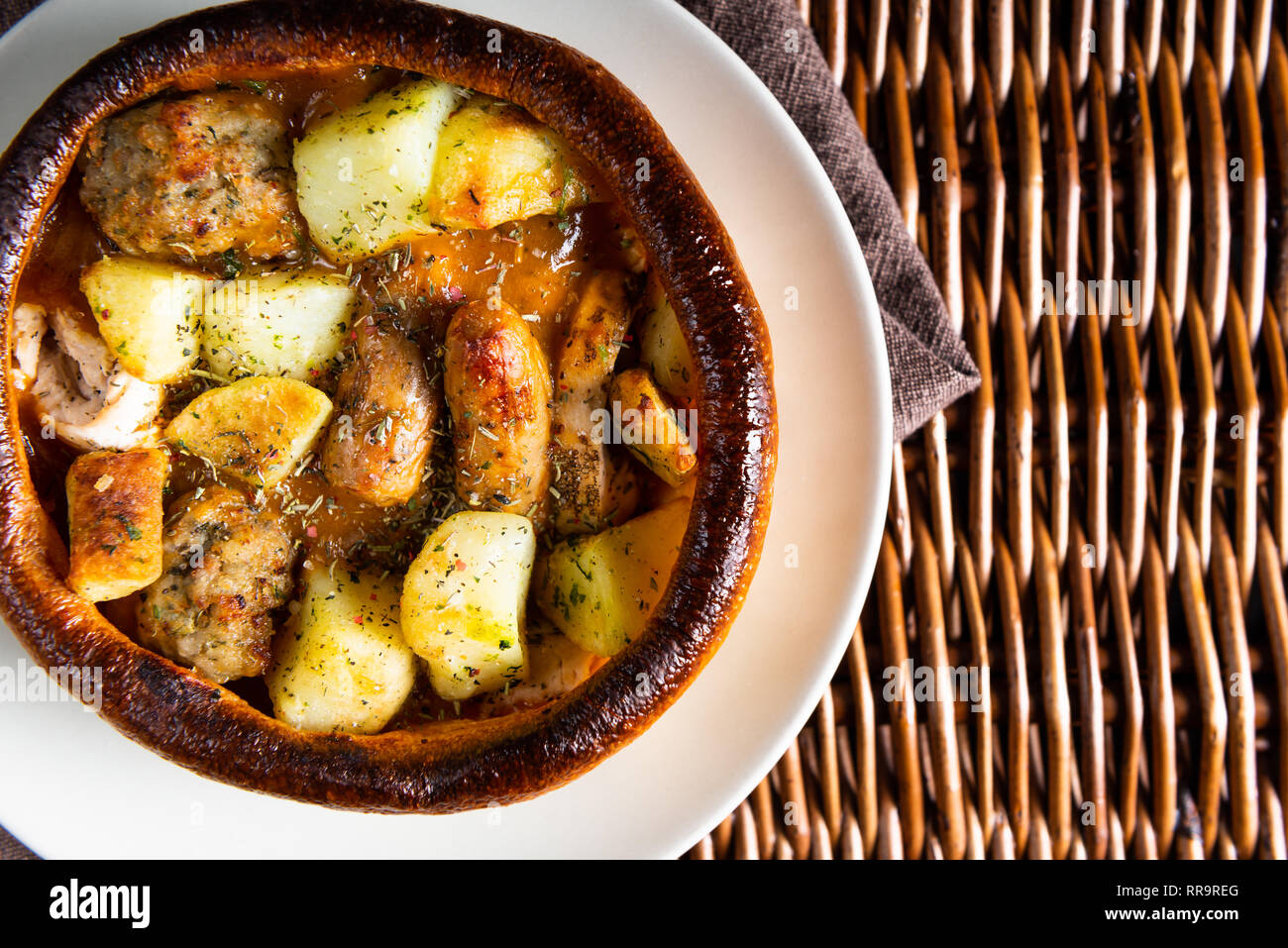 Open Pie with Potatoes and different kinds of meat on rustic background ...